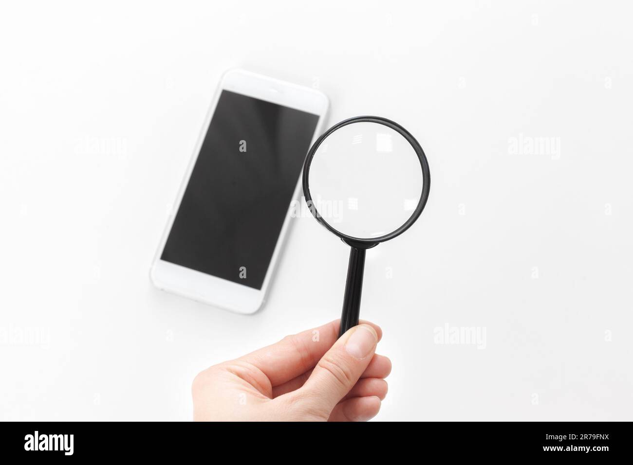 SMARTPHONE WITH MAGNIFYING GLASS Stock Photo - Alamy