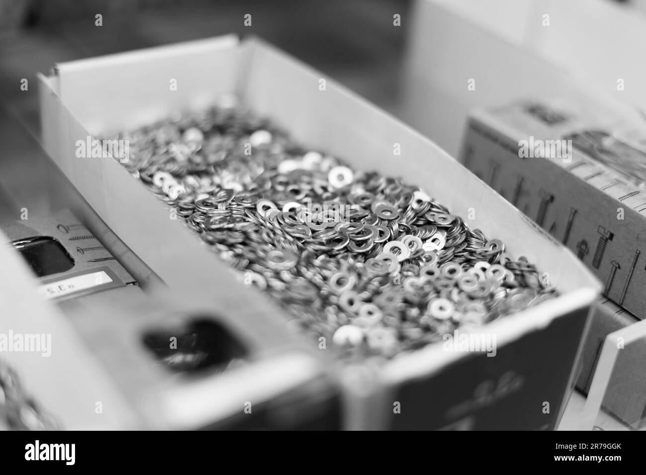 Small thin metal nails, hardware, screw lying in a store container ...