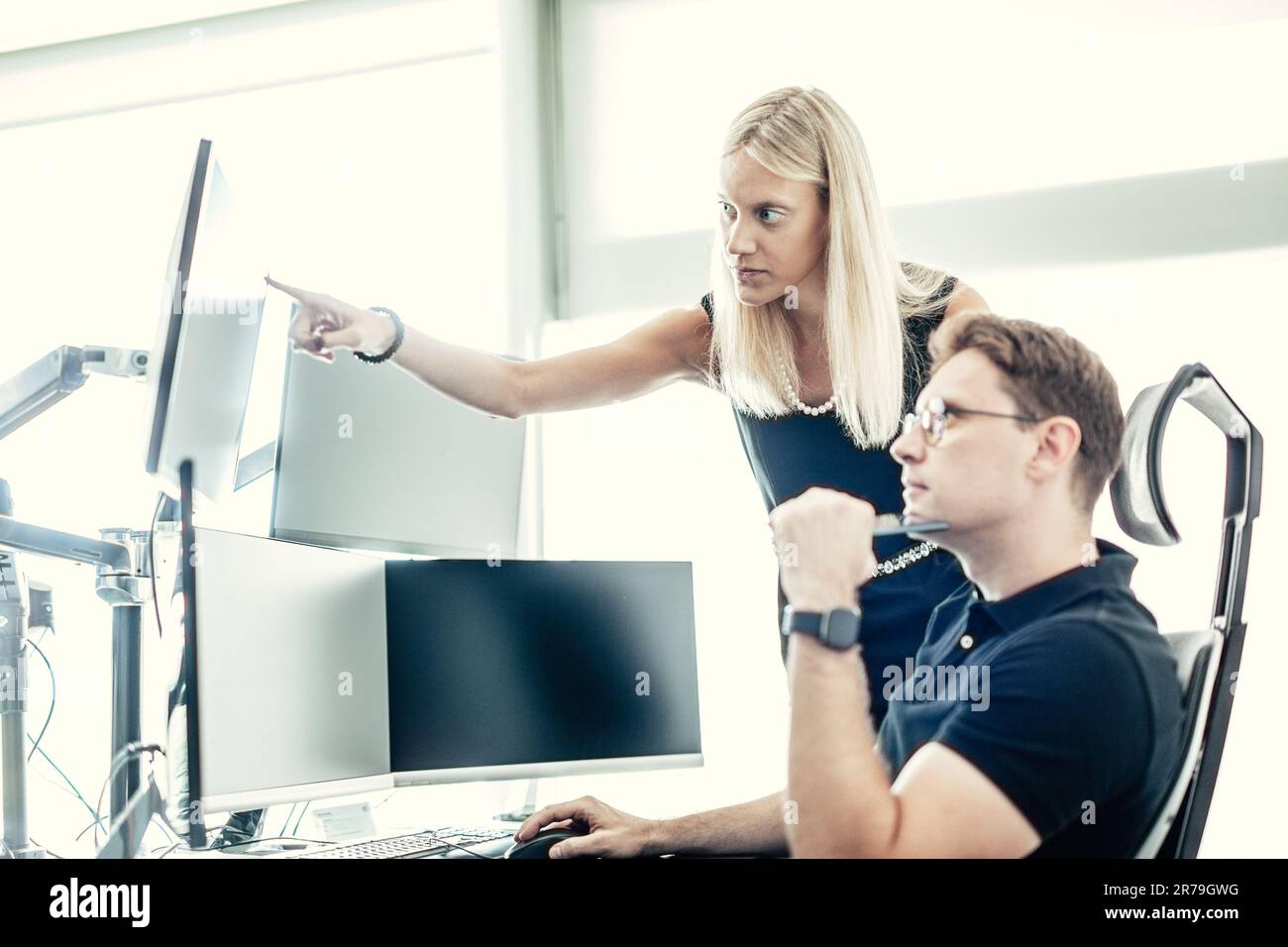 Stock broker business team trading online watching charts and data analyses on multiple computer ...