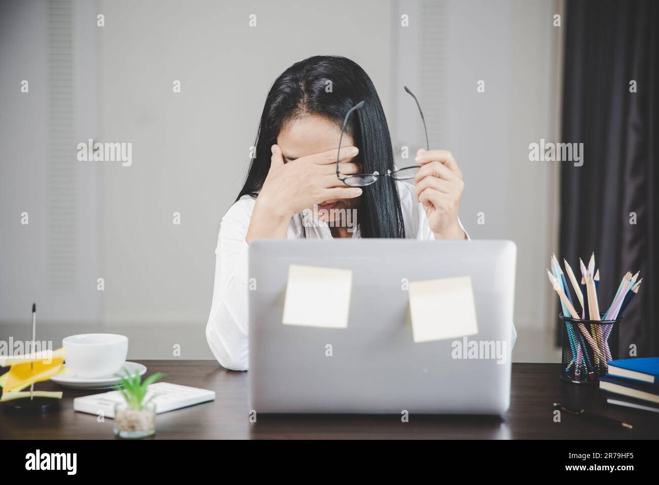 Young business woman person sleepy and has frustration eye problems ...