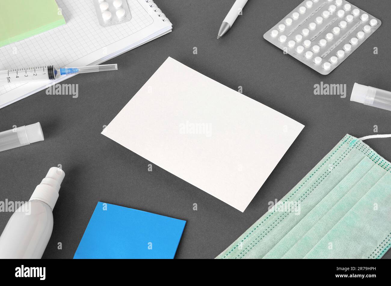 Gray modern doctor desk table with mask, notepad, syringe, sanitizer ...