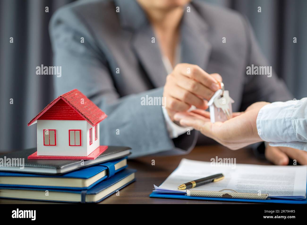 Woman home sales person is checking documents for house purchase ...
