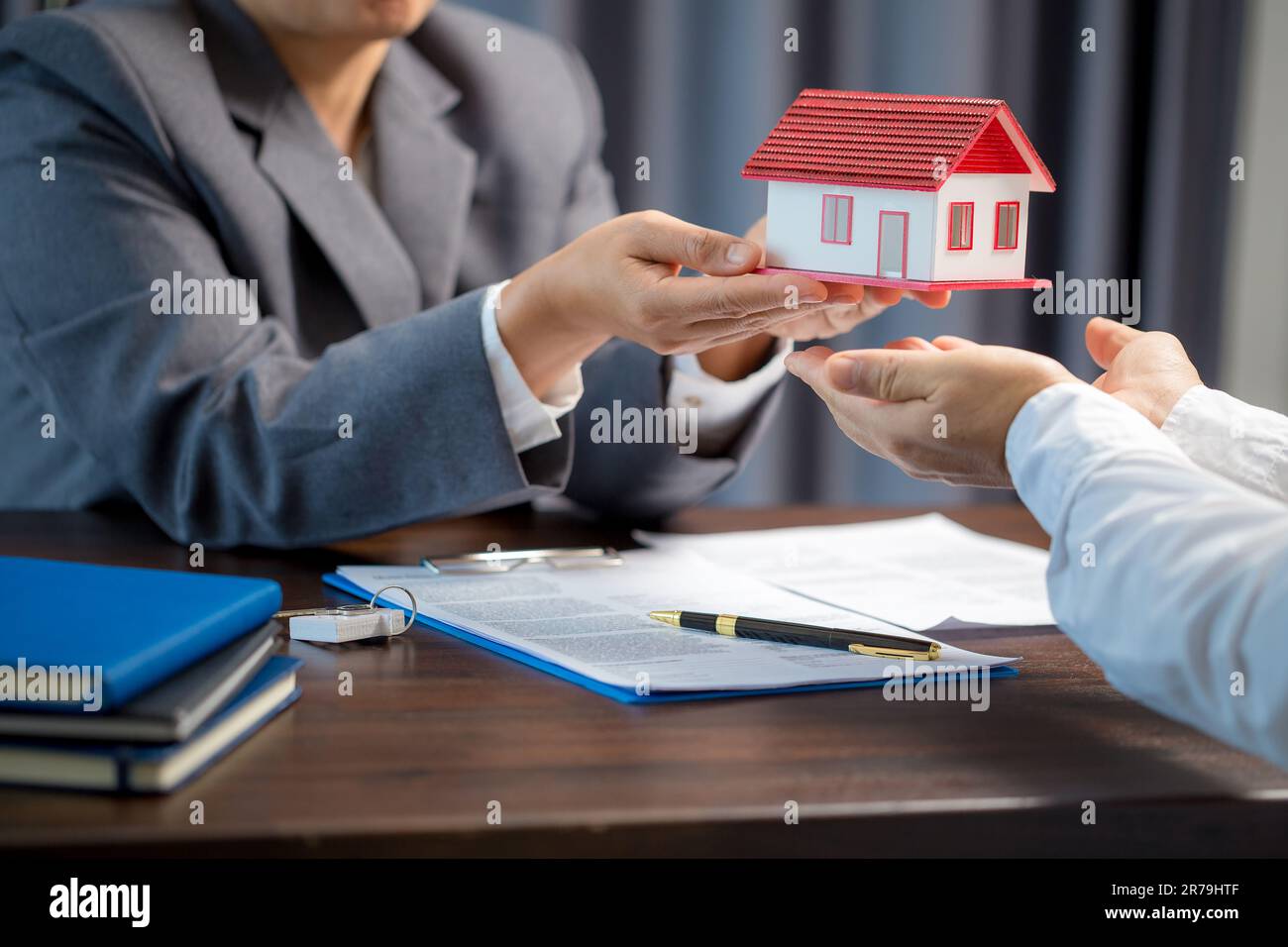 Woman home sales person is checking documents for house purchase ...