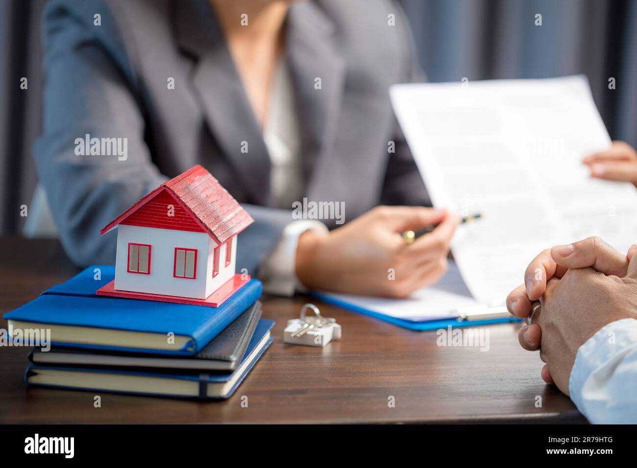 Woman home sales person is checking documents for house purchase ...