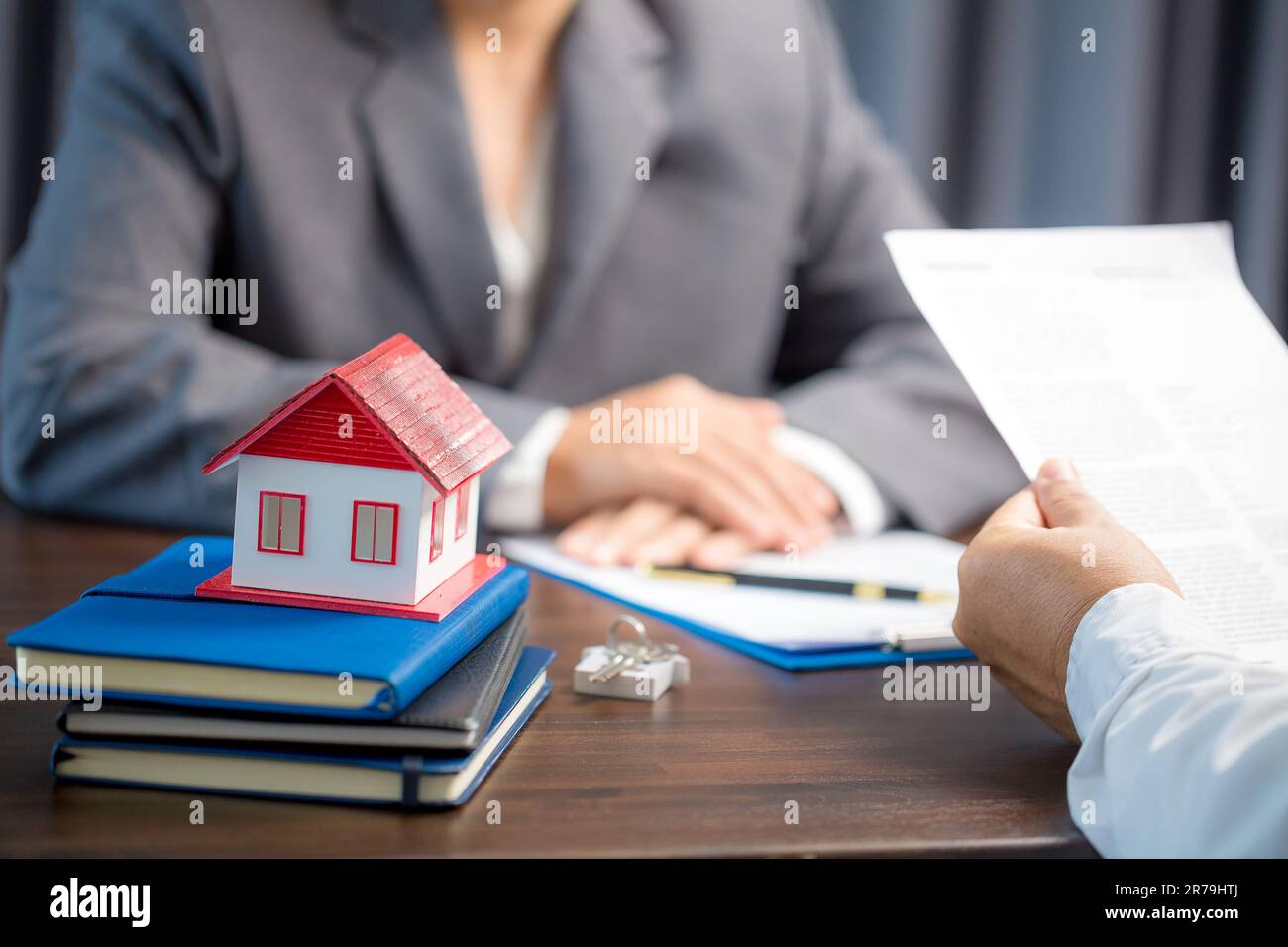 Woman home sales person is checking documents for house purchase ...