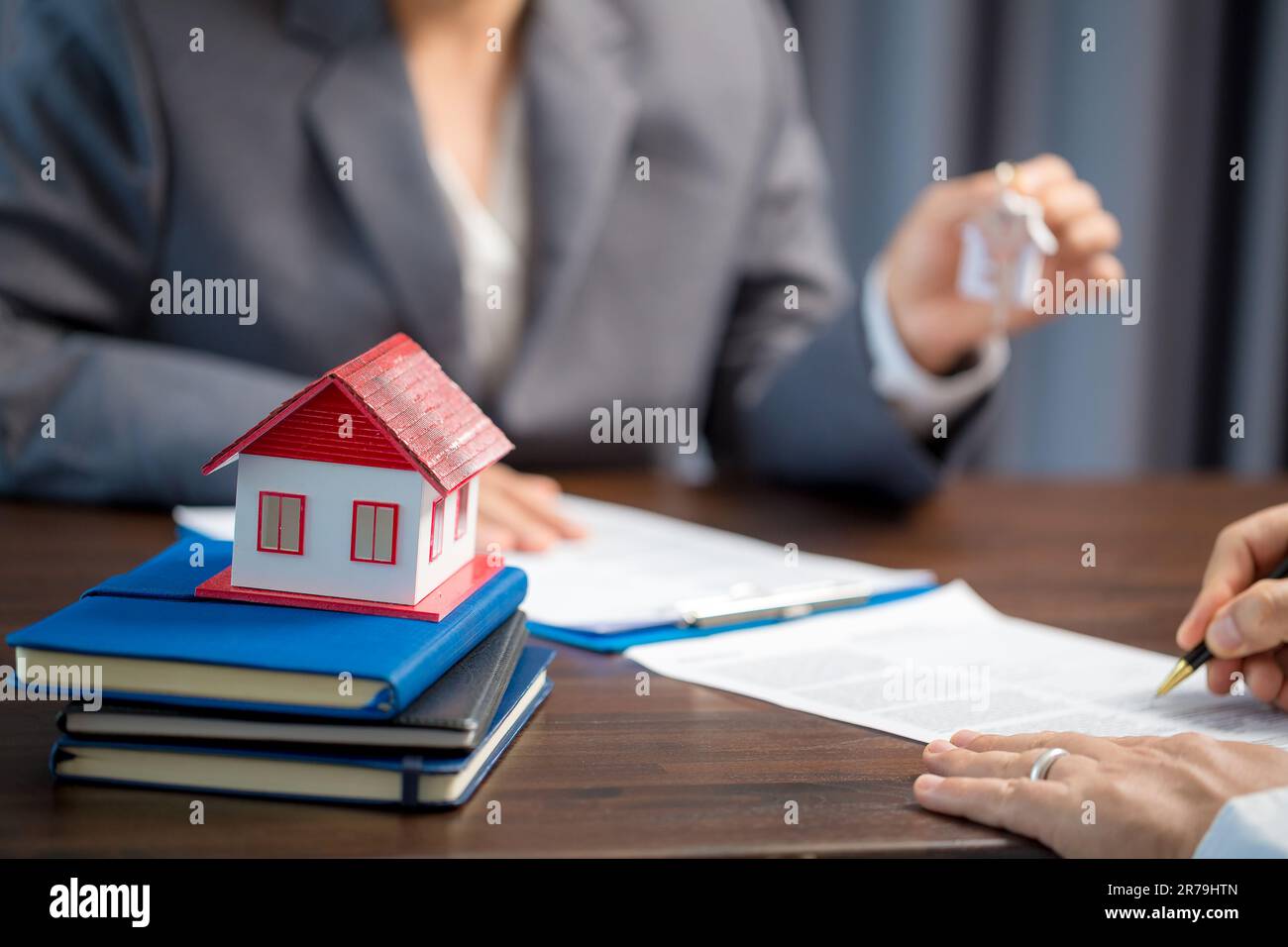 Woman home sales person is checking documents for house purchase ...
