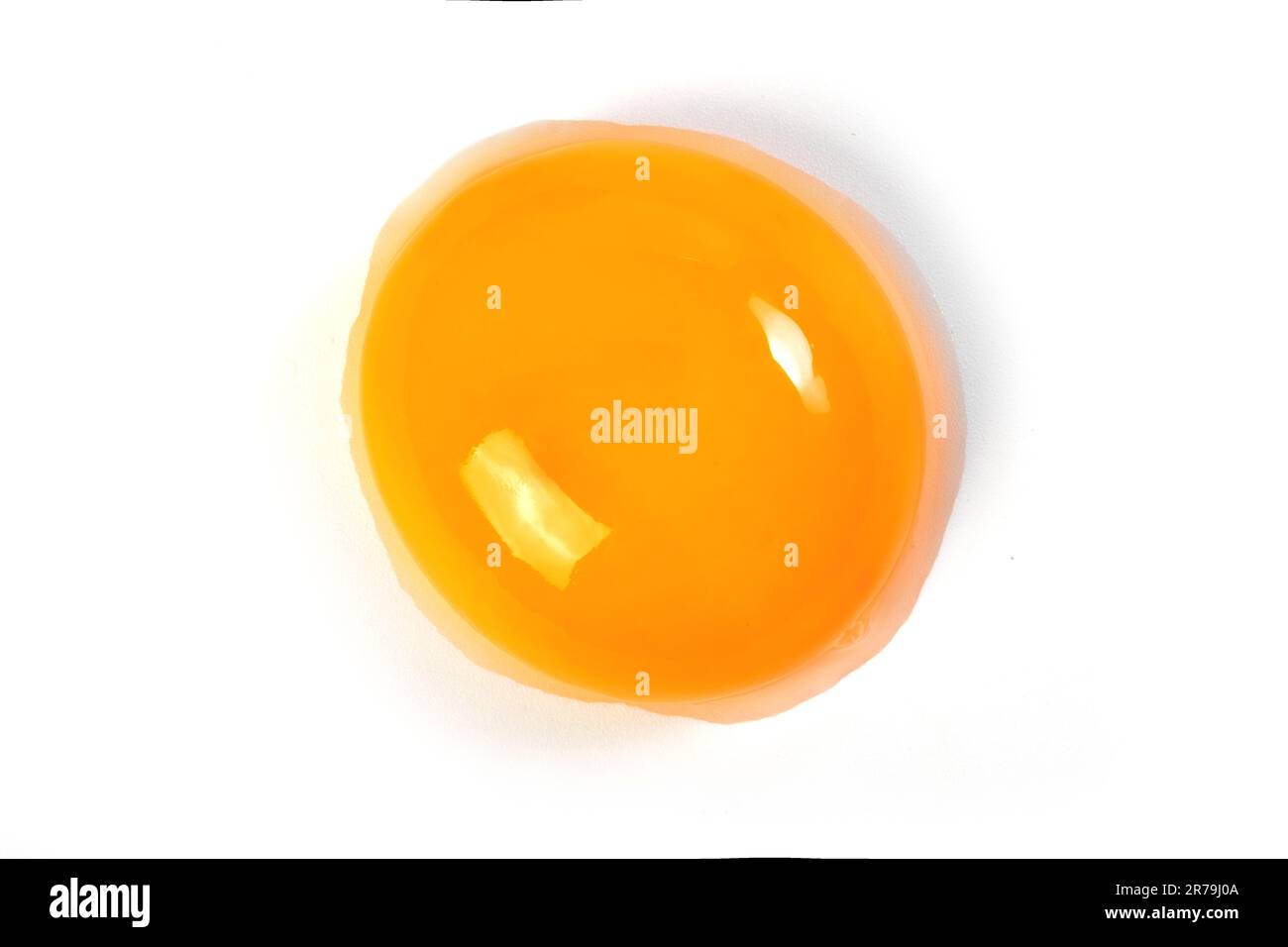 Raw egg yolk on a white background. Close-up. View from above. Protein ...