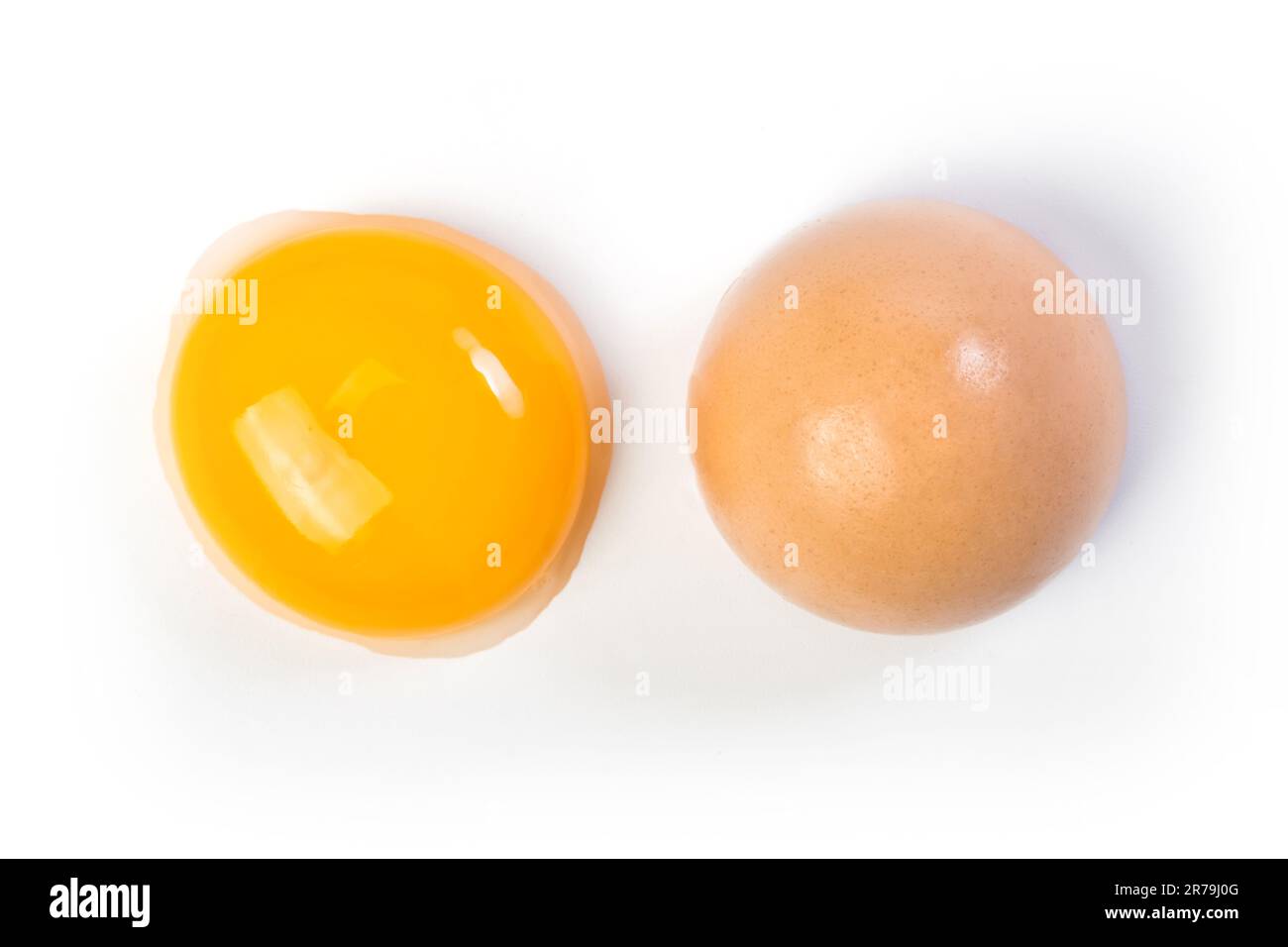 Egg yolk and shell on a white background. Top view Stock Photo - Alamy
