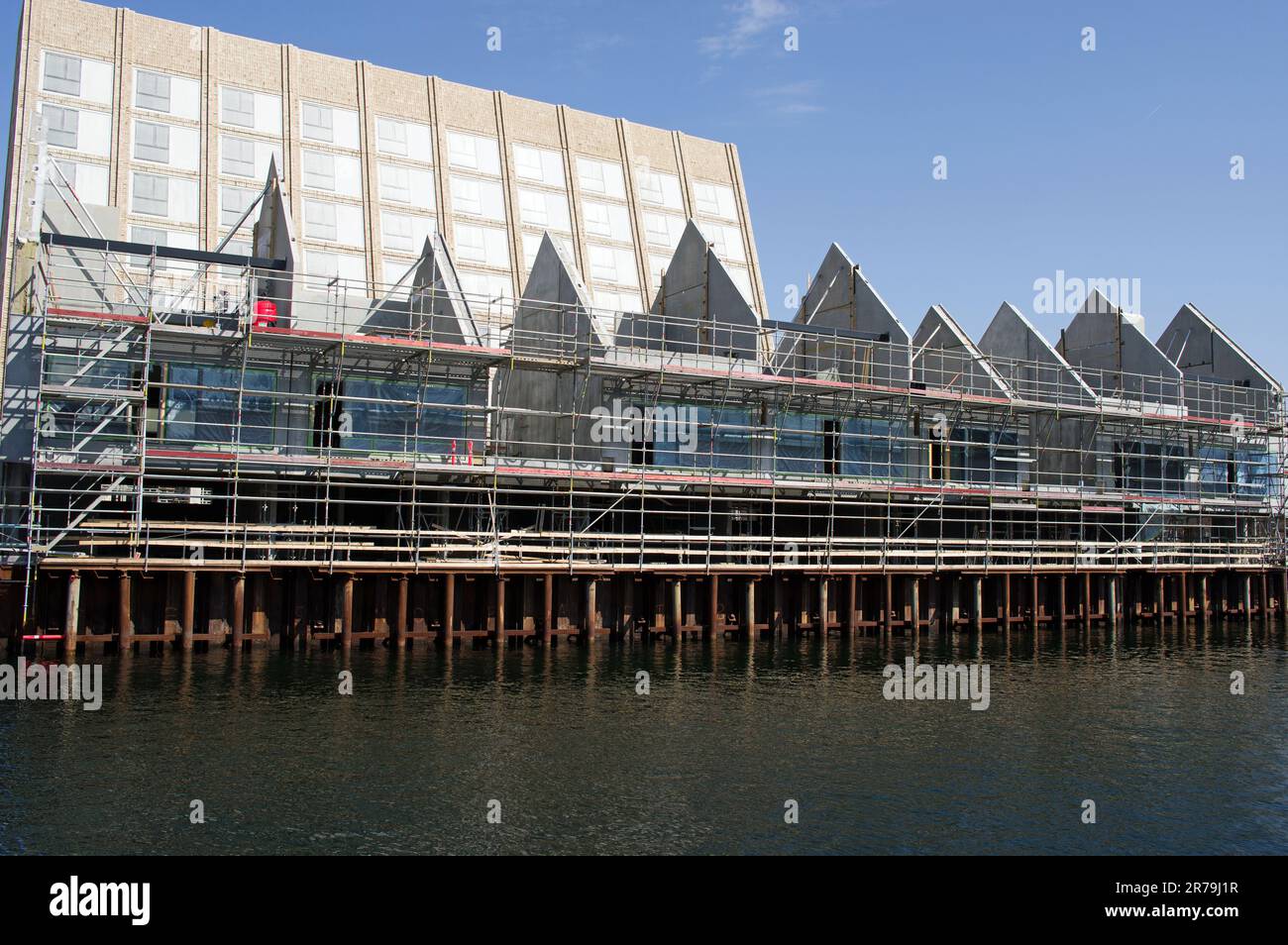 Terraced houses under construction on a quay in Copenhagen in denmark ...