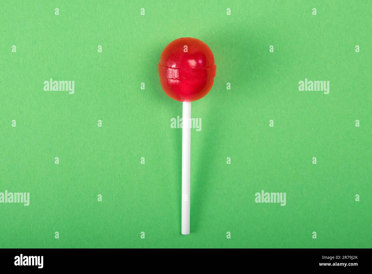 Red lolipop on green pastel background. sweet candy concept Stock Photo ...