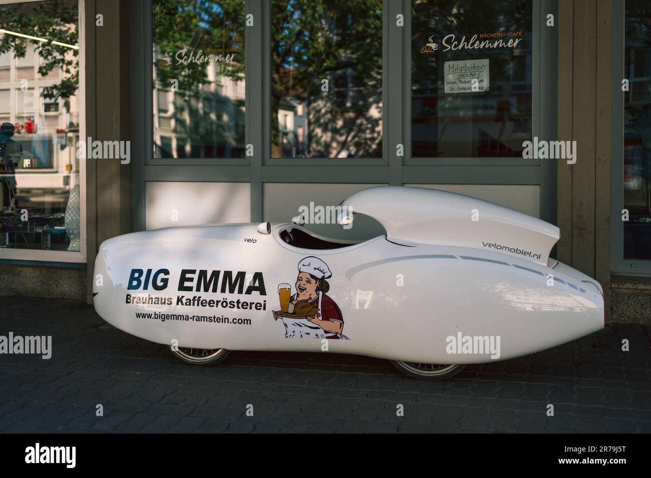 Futuristic looking four wheel (velomobile) vehicle parked in front of a ...