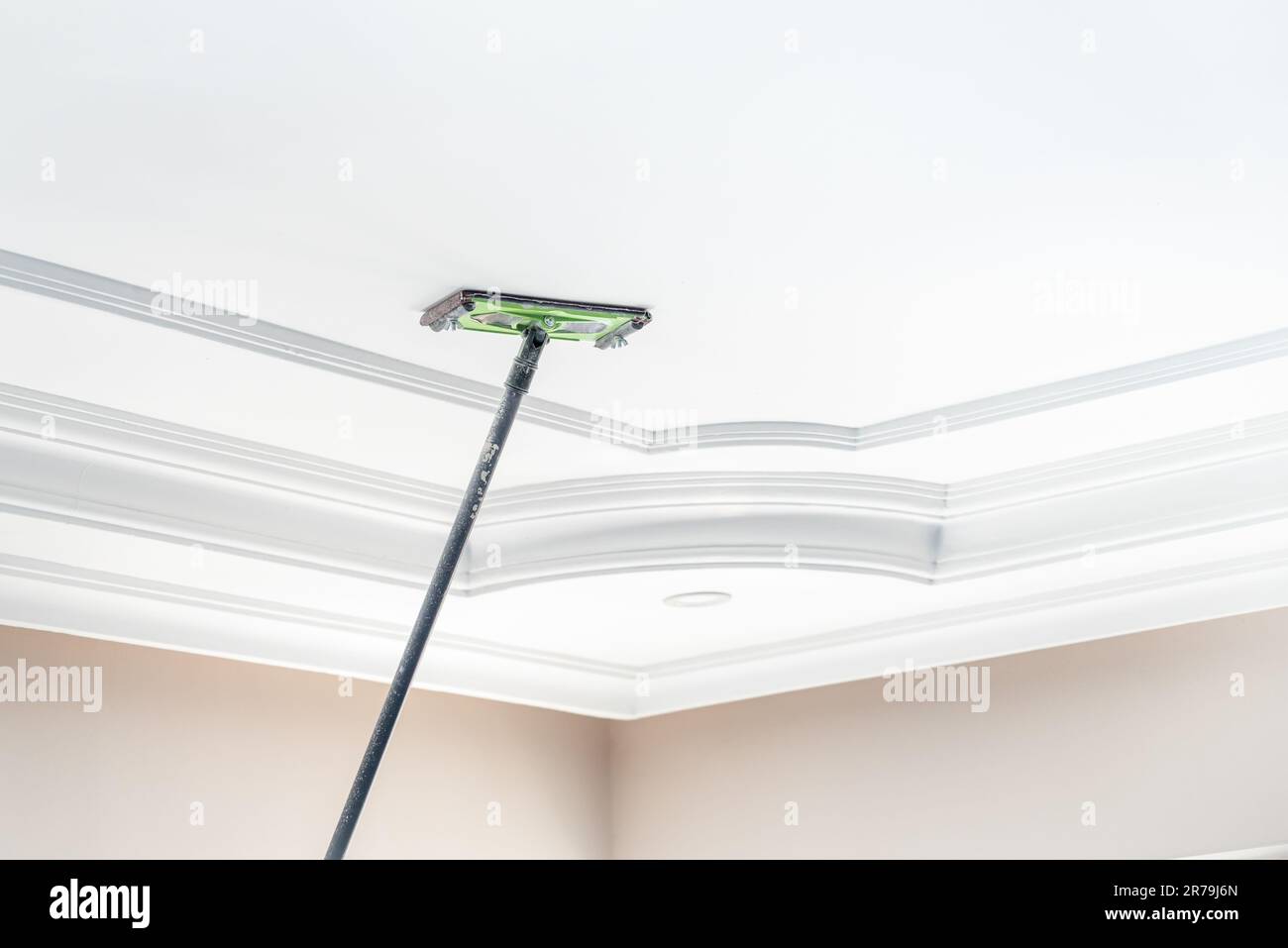The master sanding the plaster on the ceiling of the room to be painted ...