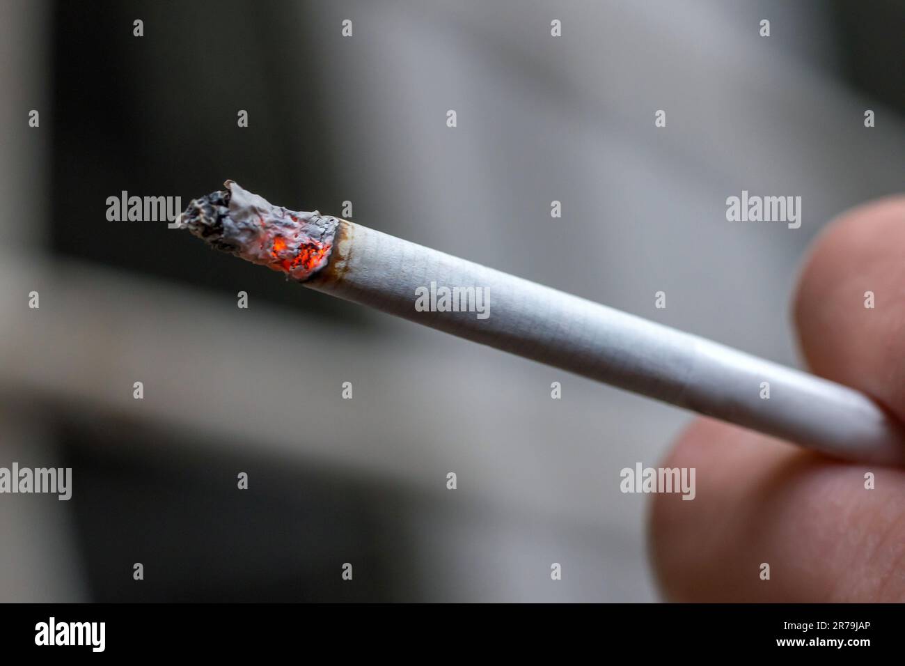 Woman holding lit cigarette in hi-res stock photography and images - Alamy