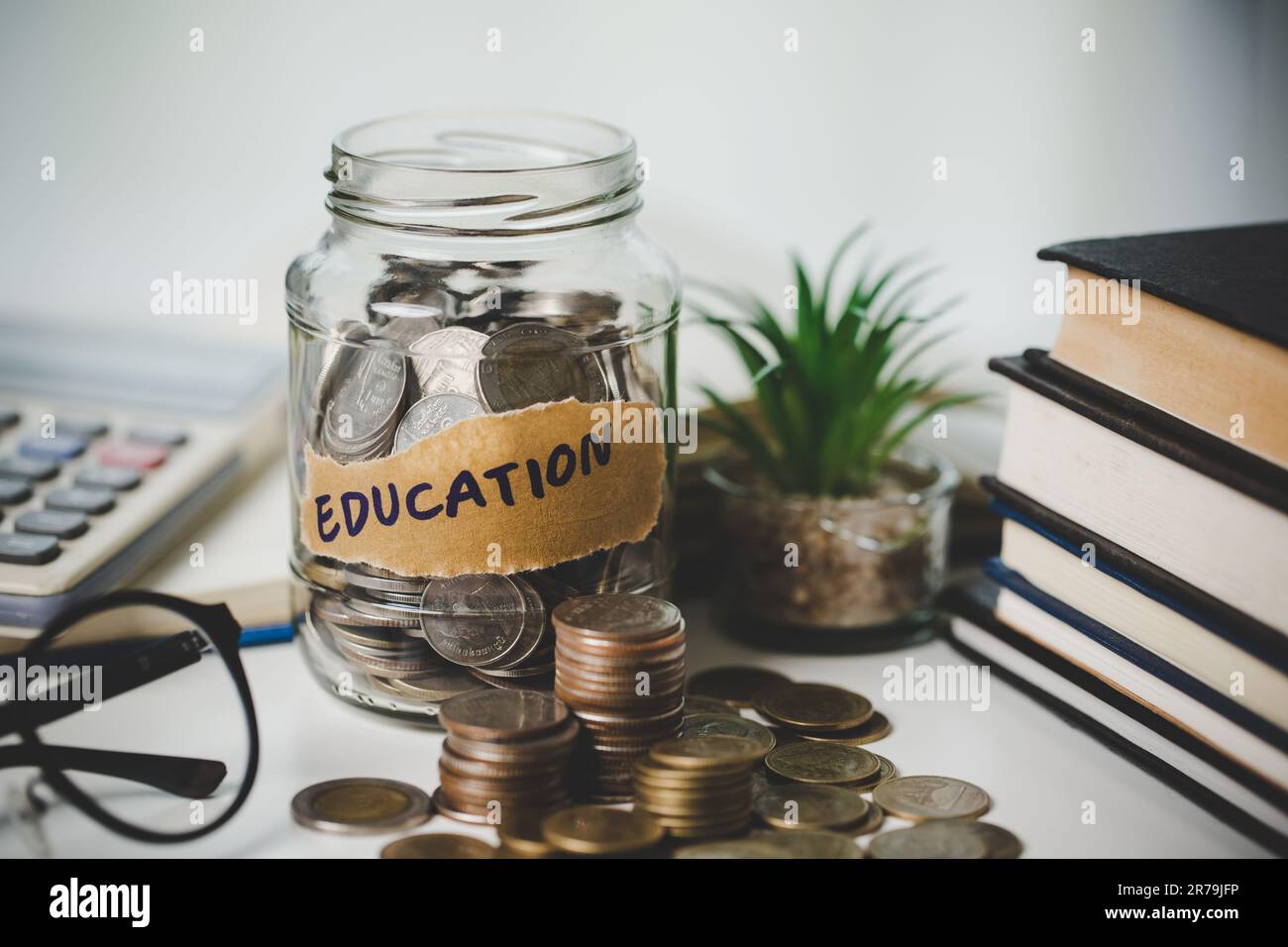 close-up education object with stack money coin-cash dollar and glass ...
