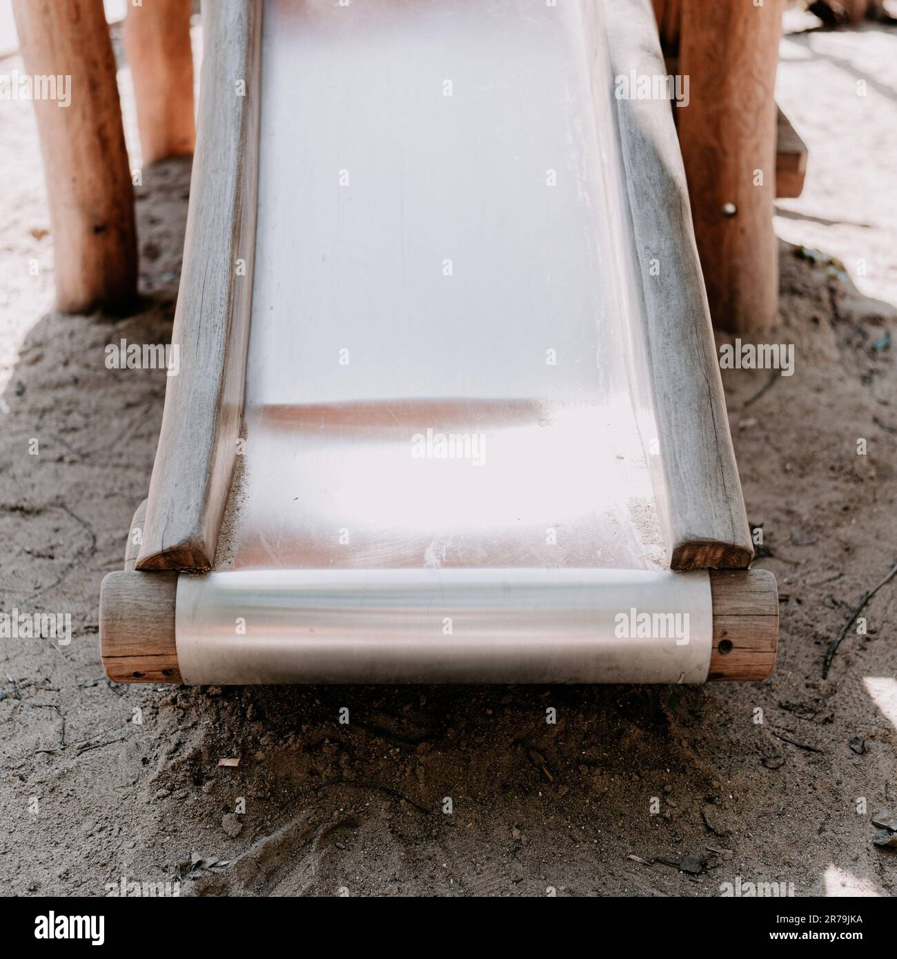 A metal slide with a curved section at the base Stock Photo - Alamy