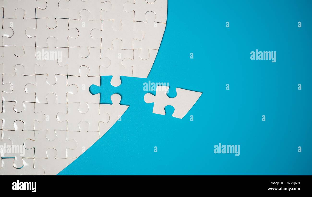 White part of jigsaw puzzle pieces on blue background. concepts of ...