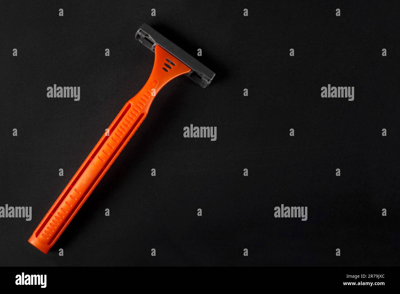 New disposable razor blade on a black background. Close-up, top view ...