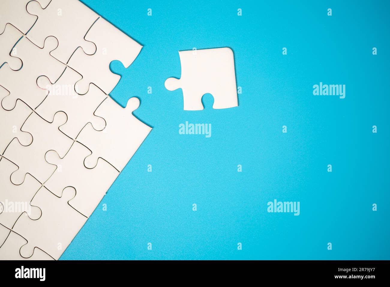 White part of jigsaw puzzle pieces on blue background. concepts of ...