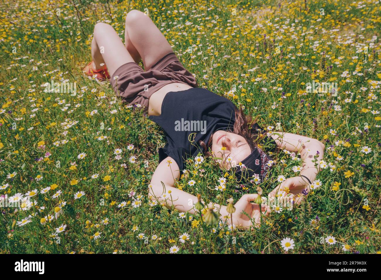Girl lying and sleeping in spring field with grass and flowers Stock ...