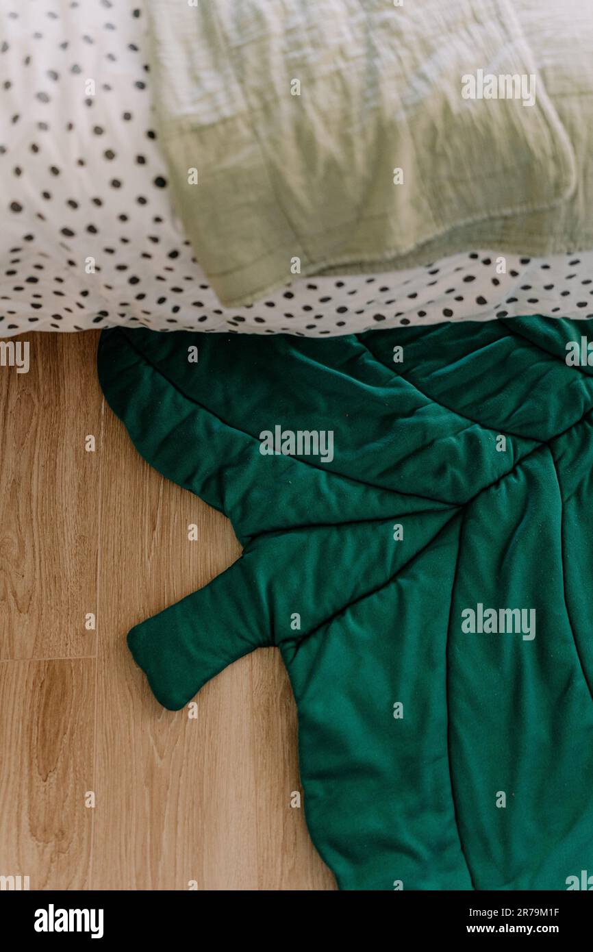 A cozy bedroom with a calm green color palette and wooden accents Stock ...
