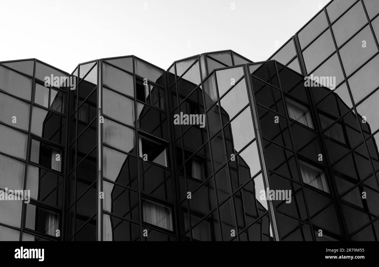 A grayscale of an exterior view of a modern business building featuring ...