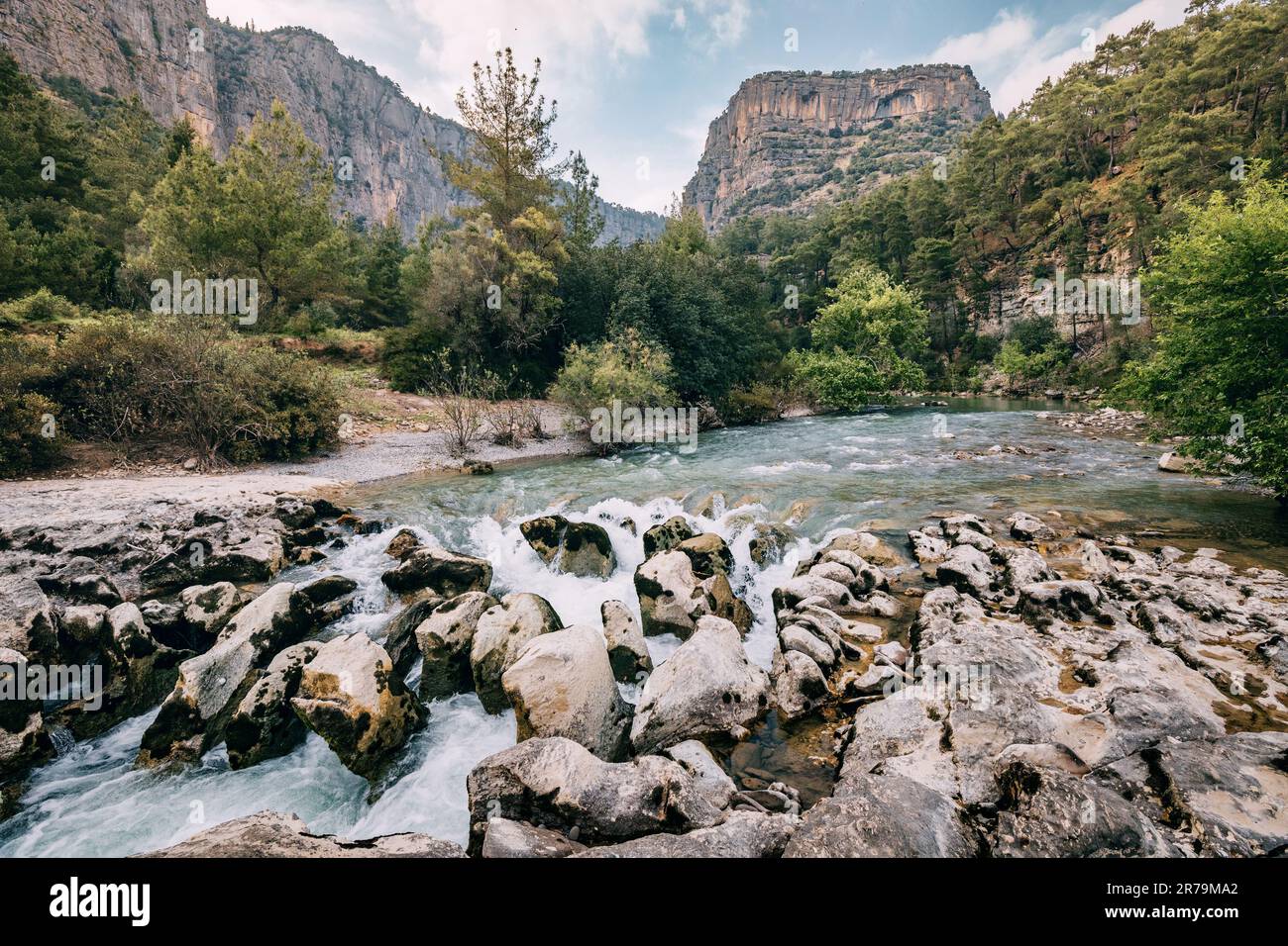 A narrow gorge with a stormy mountain river and picturesque rapids ...