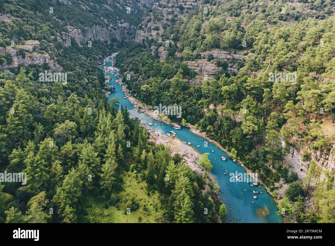 Aerial view of azure blue winding river in deep canyon surrounded by ...