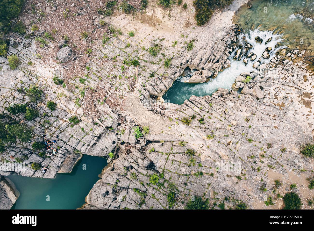 Aerial view of azure blue winding river and bridge in deep canyon ...