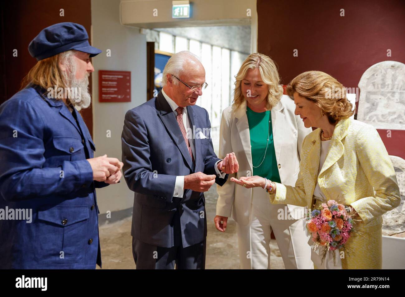 Swedens King Carl XVI Gustaf mints a coin during his visit with Queen ...