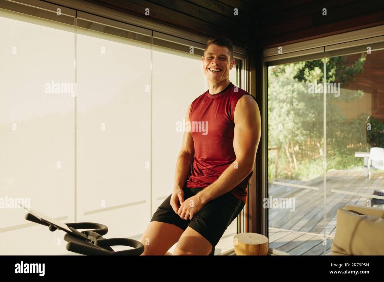 Happy young man getting into the swing of his workout routine with the ...