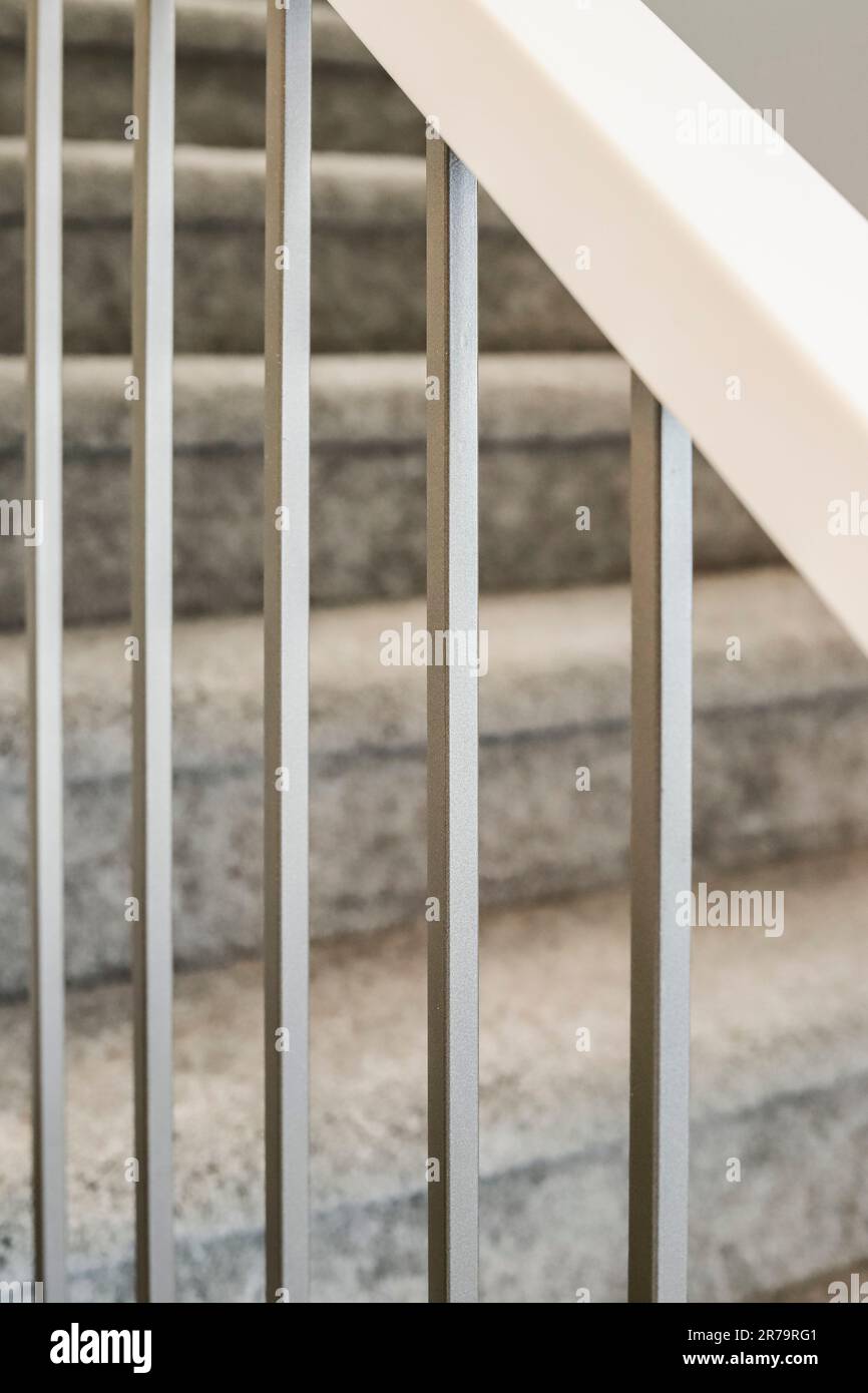 A vertical of white-railed stairs in a modern architectural design ...