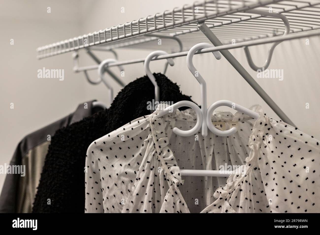 An interior design of clothes hanging on a hanger Stock Photo - Alamy