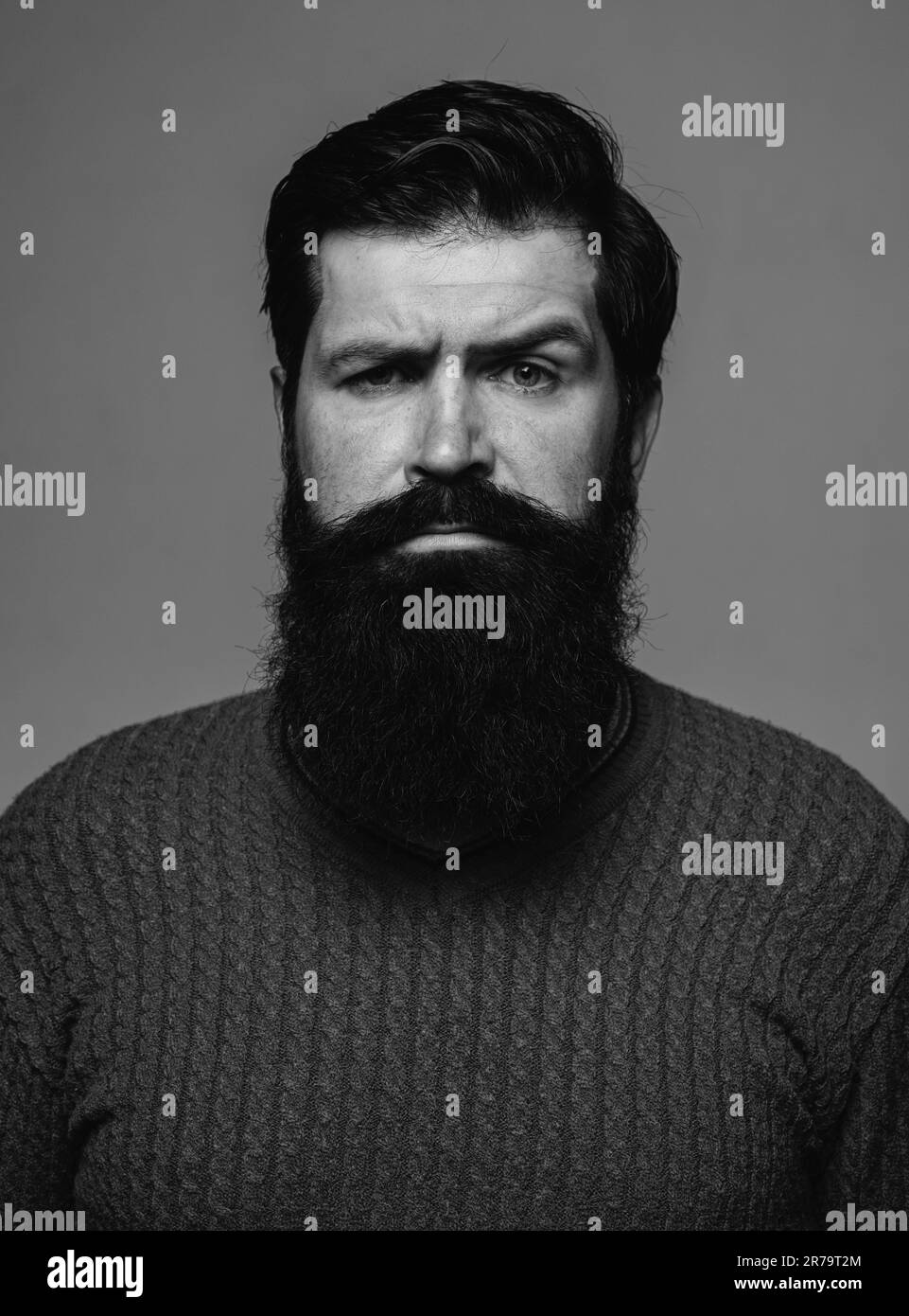 Confident man has beard and mustache, looks seriously, isolated ...