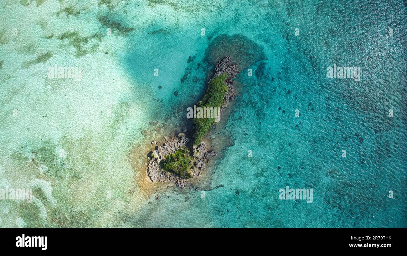 A tranquil scene of a small island located off the coast of a pristine ...