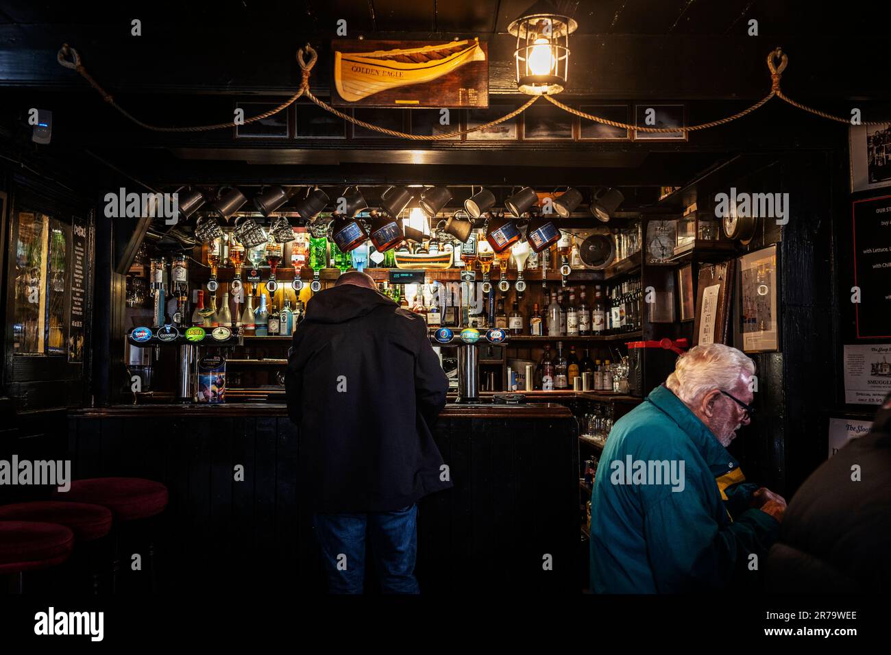 A customer waiting at the bar to be served inside the historic Sloop ...