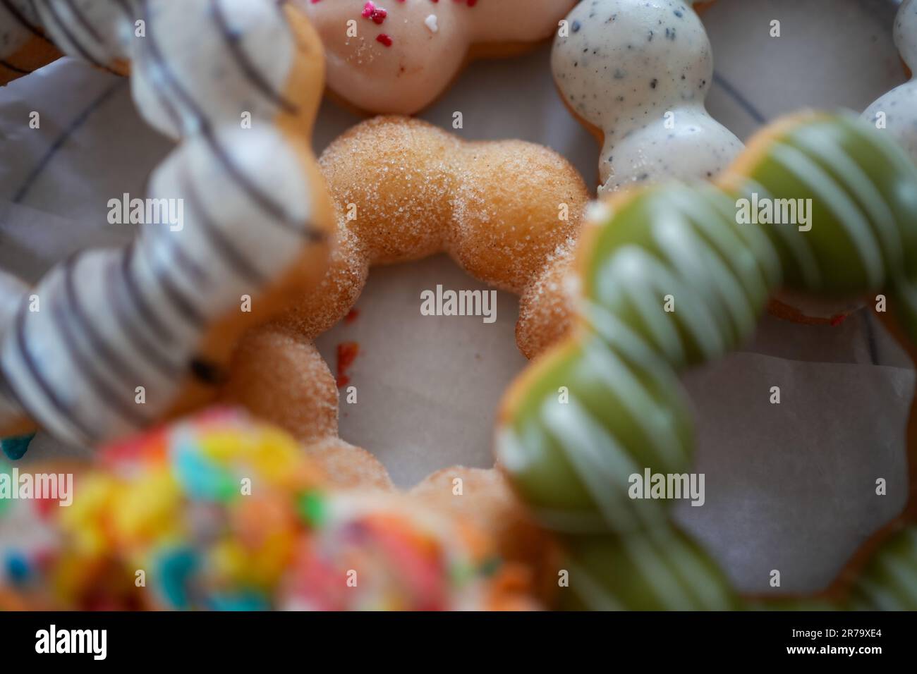 A closeup of a stack of fresh doughnuts in various toppings Stock Photo ...