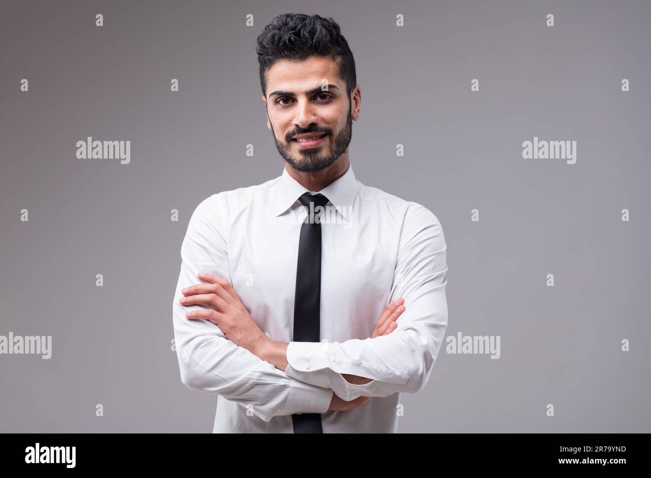 A handsome dark-skinned man in a white shirt, black tie. His well ...