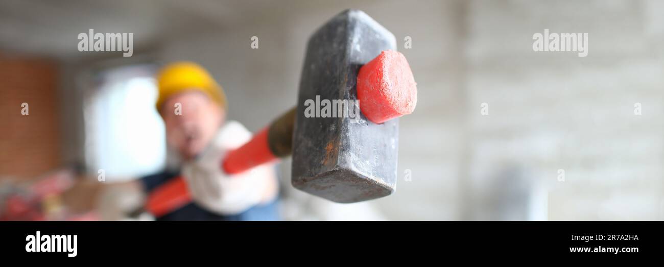 Builder holding a construction hammer at construction site closeup ...