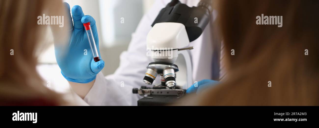 Scientists in the laboratory examine blood sample in sample tube Stock ...