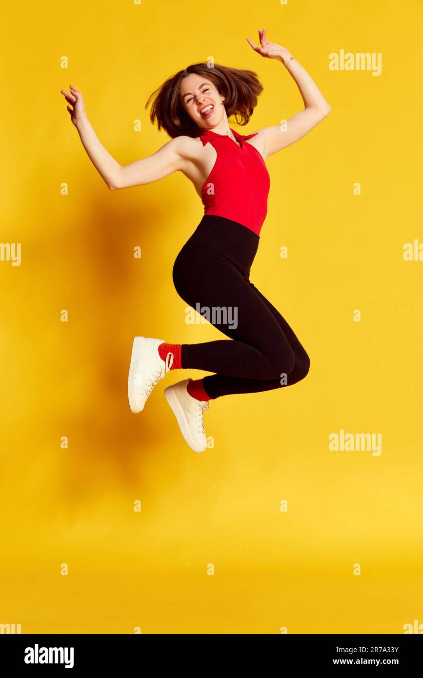 Full-length portrait of young beautiful girl in casual clothes ...