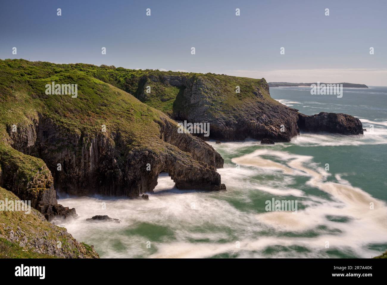 Natural arch in the cliffs near Shrinkle Haven on the Pembrokeshire ...