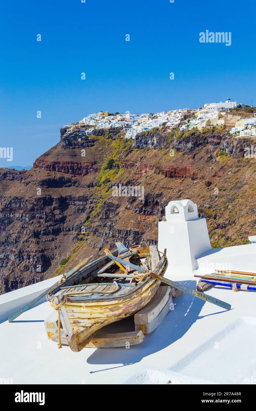 Old fishing boat tourist attraction on dazzling white rooftop of a cave ...