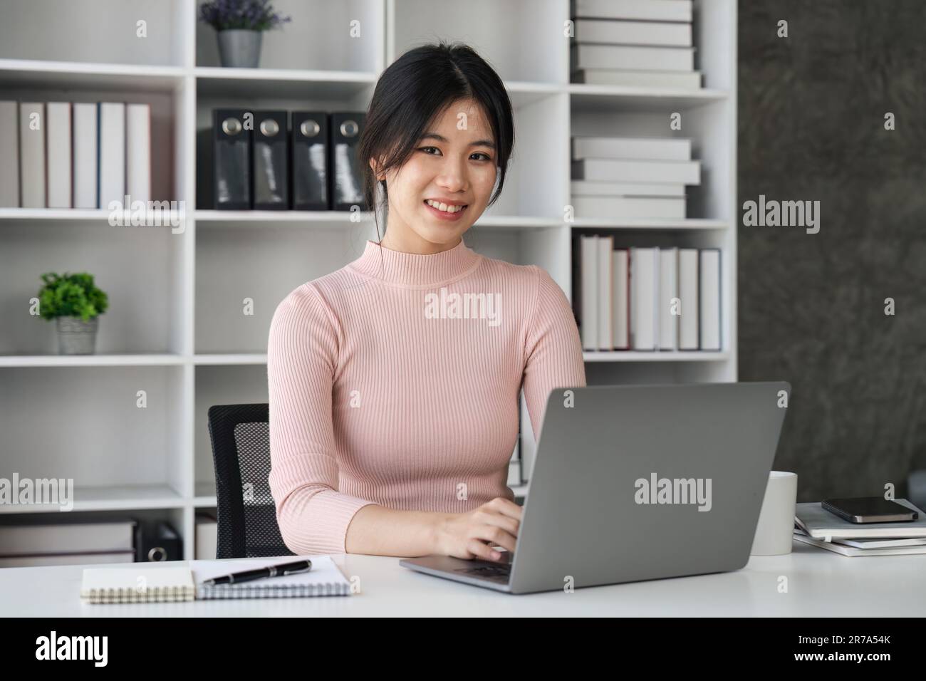 Beauitul young woman working using computer laptop smile looking at ...