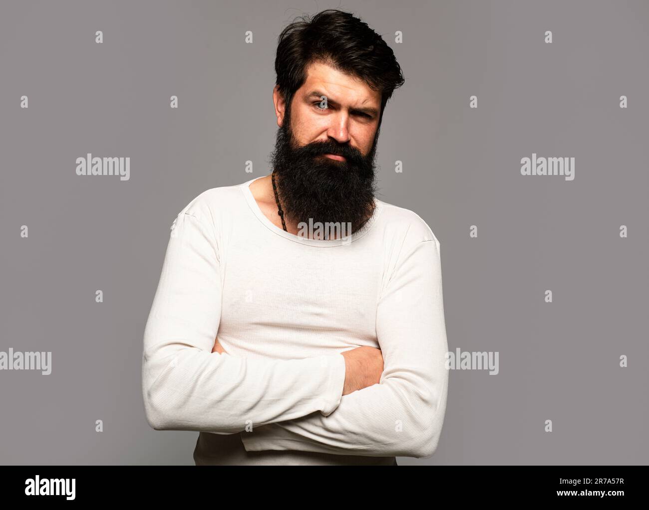 Portrait of confident serious man has beard and mustache, looks seriously, isolated. Hipster guy ...