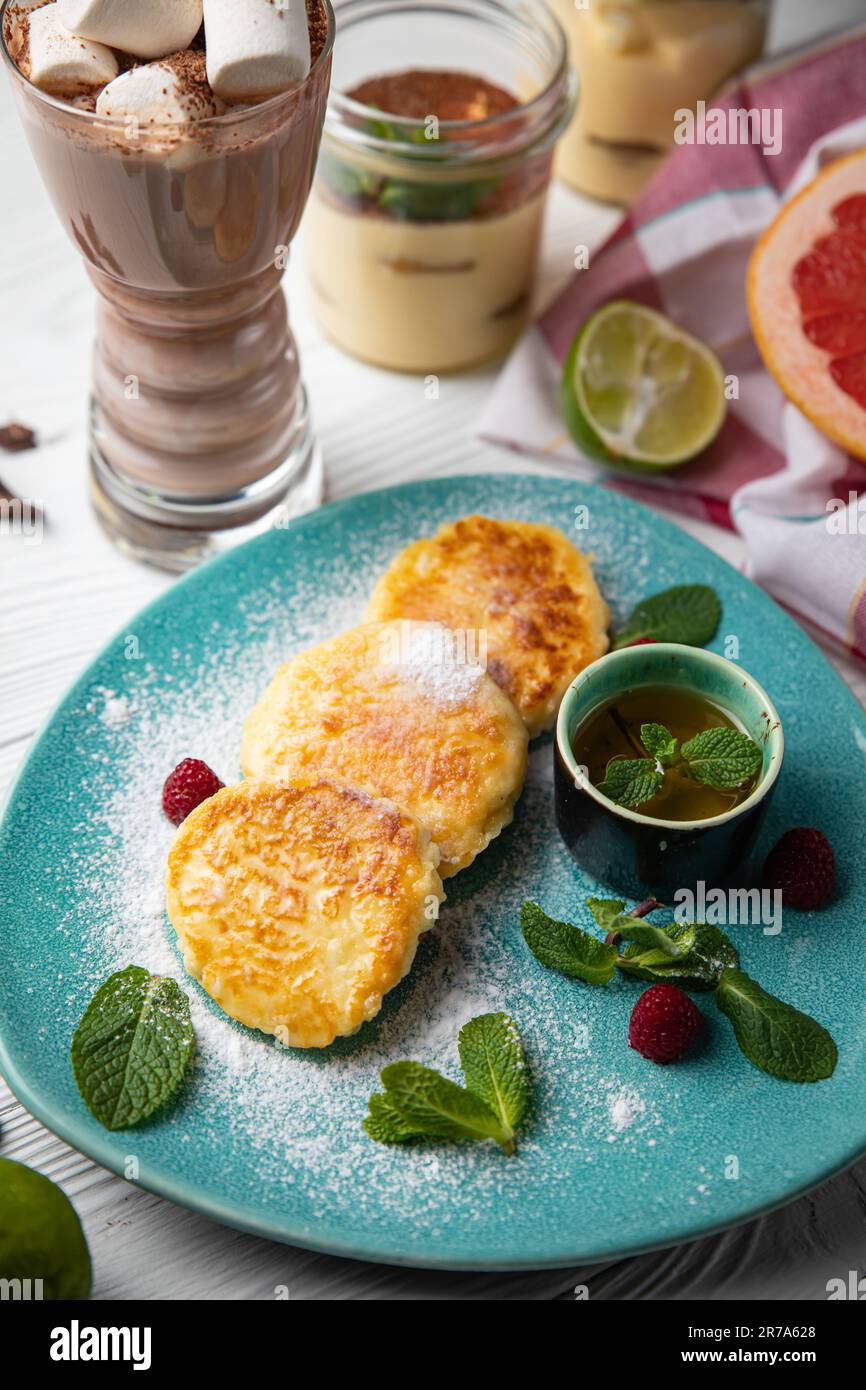 A white porcelain plate with a freshly cooked crepe topped with whipped ...