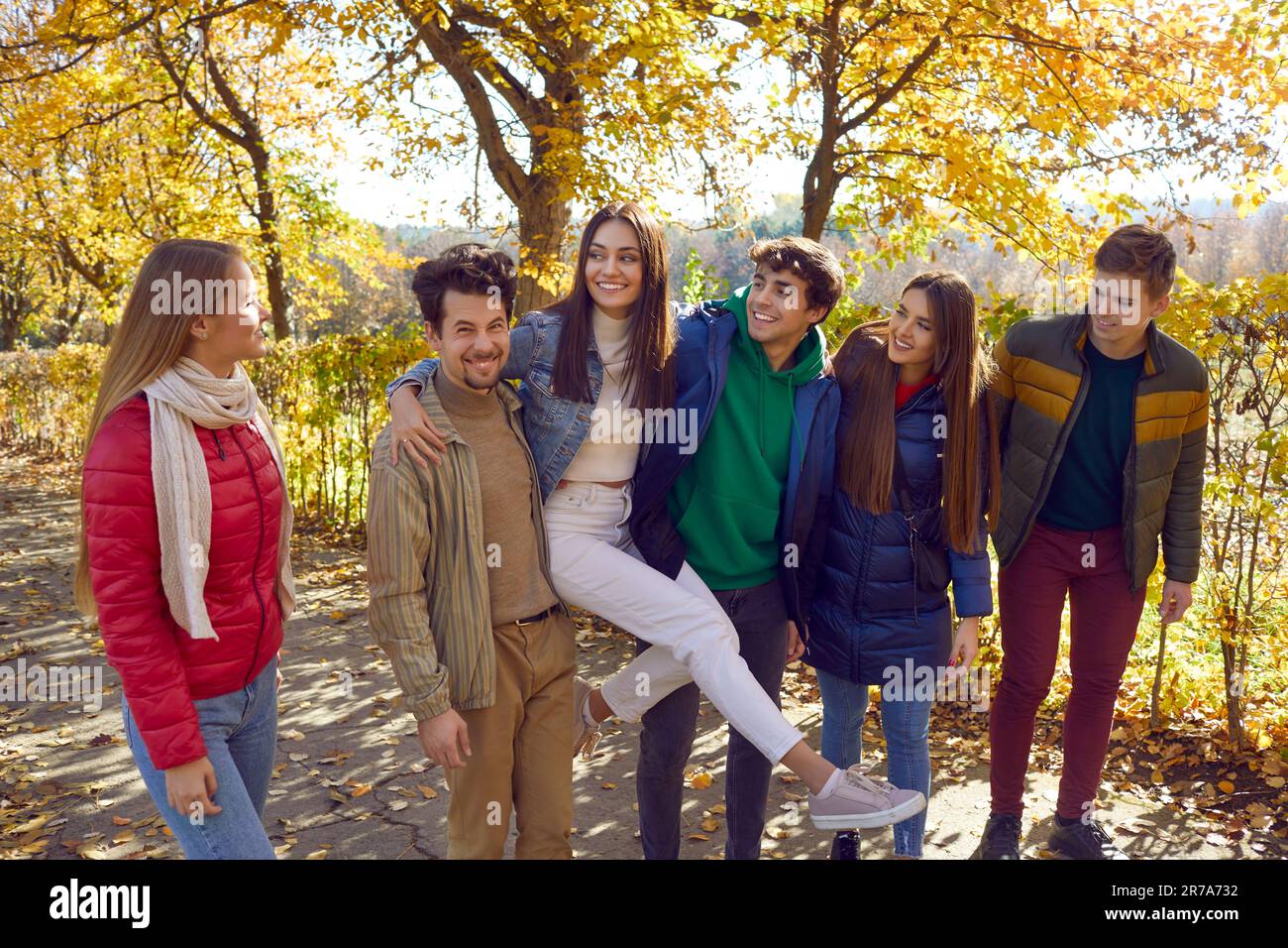 Group of happy friends walking together on nature in autumn Stock Photo ...