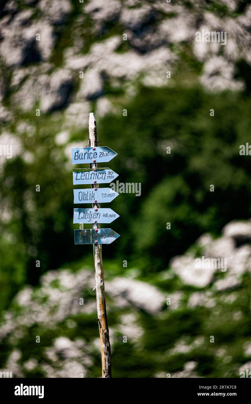 A wooden sign with three different languages printed on it Stock Photo ...
