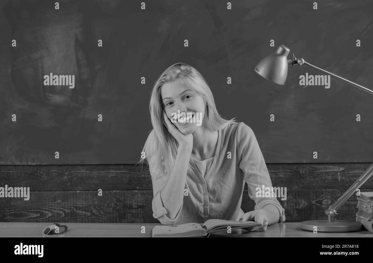 Learn with fun. Funny female teacher sitting at her workplace and ...