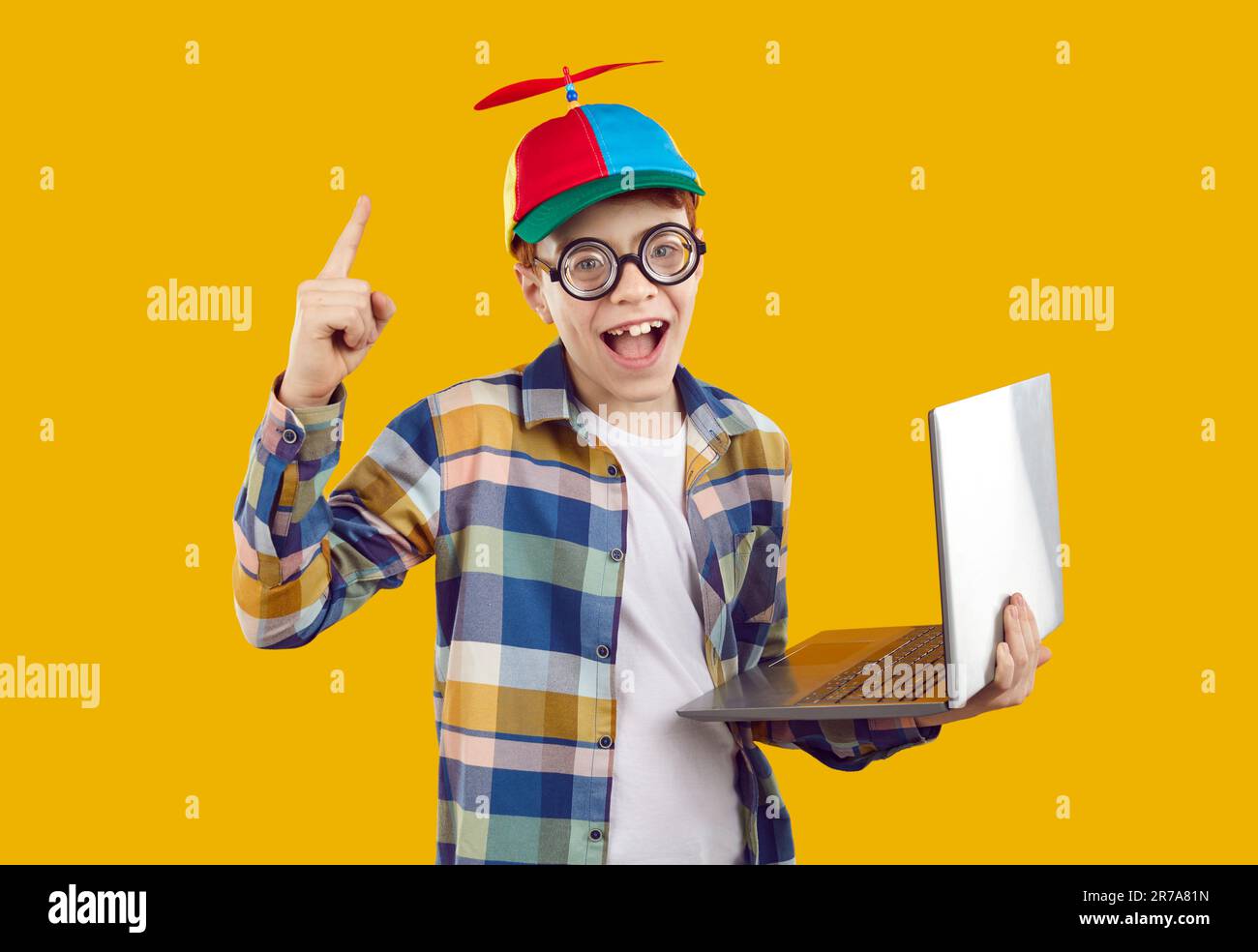 Funny happy school child in propeller cap has genius idea while using ...