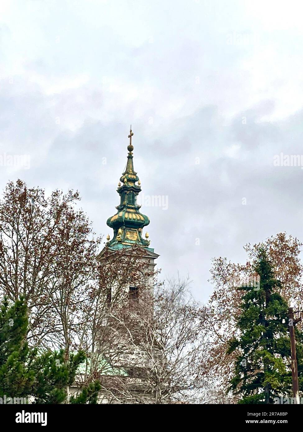 An architectural structure featuring a tall spire rising up from one of ...